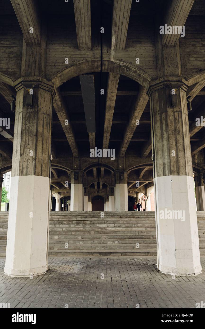Old stone bridge structure from below with white columns in Bilbao city ...