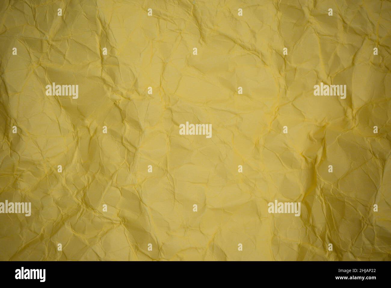 Crumpled yellow paper background Stock Photo - Alamy