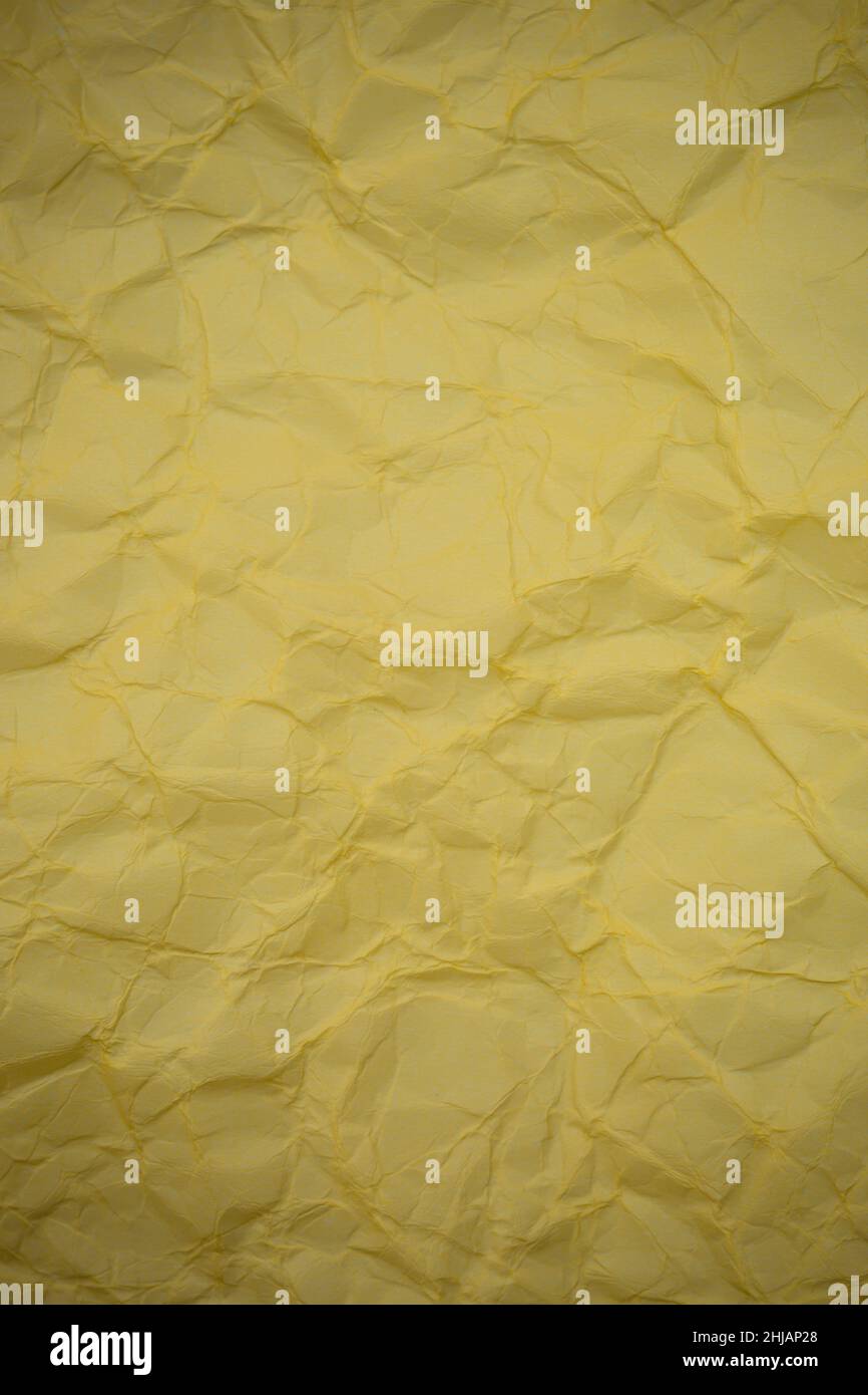 Crumpled yellow paper background Stock Photo - Alamy