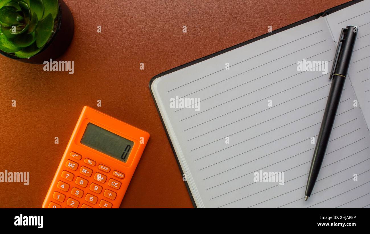 Flat layout of blank paper sheet, notebooks, calculator and pen on ...