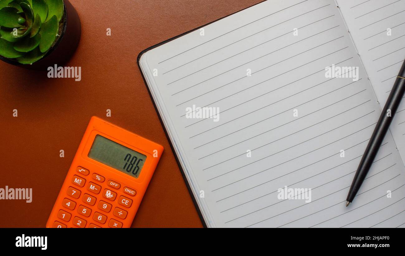 Flat layout of blank paper sheet, notebooks, calculator and pen on ...