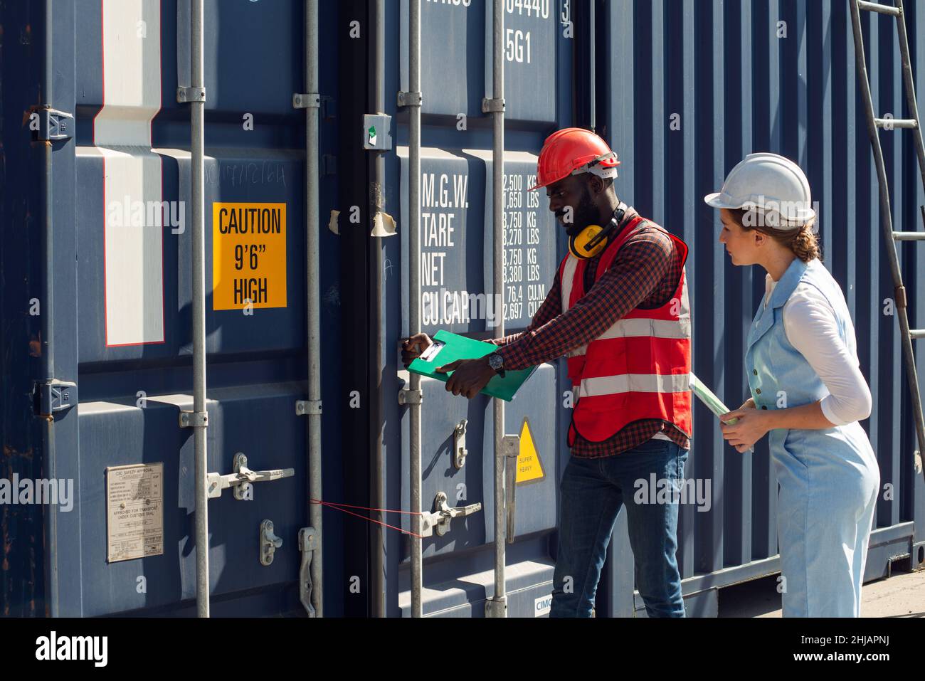 Businesswoman and engineer talking and checking loading Containers box ...
