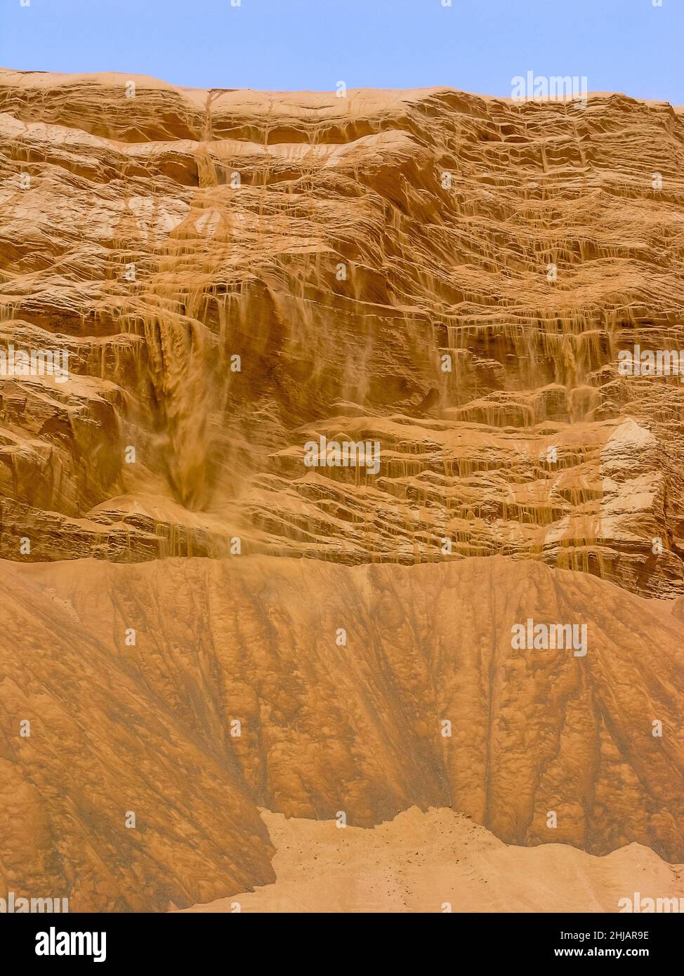 A 'waterfall' of sand cascading from a dune in the desert near Dubai in ...