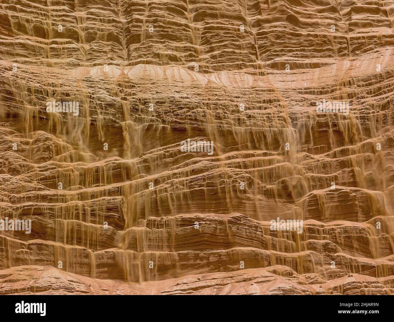 A 'waterfall' of sand cascading from a dune in the desert near Dubai in ...