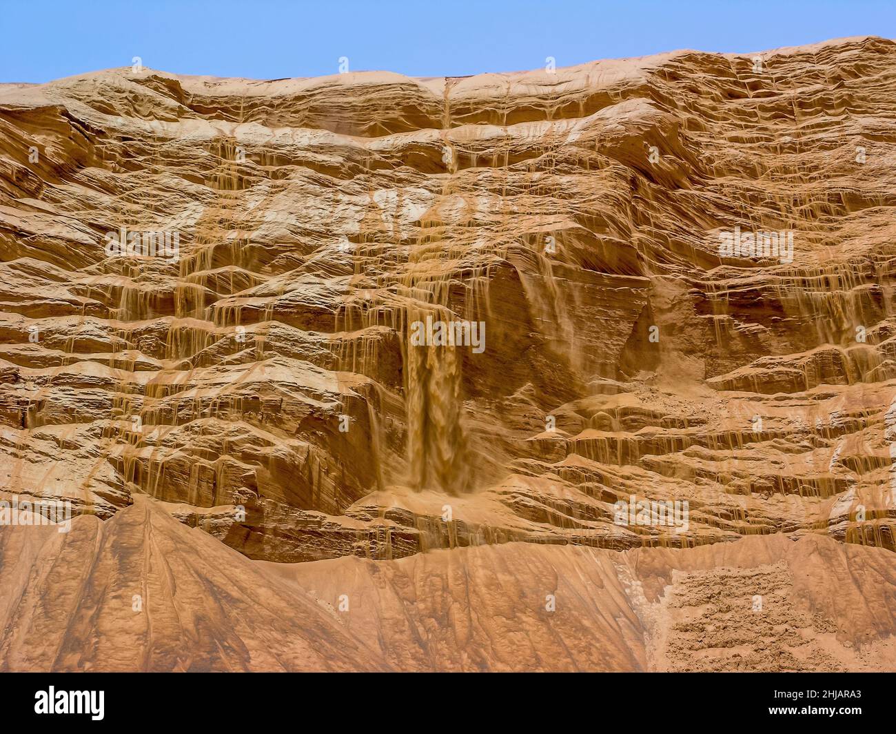 A 'waterfall' of sand cascading from a dune in the desert near Dubai in ...