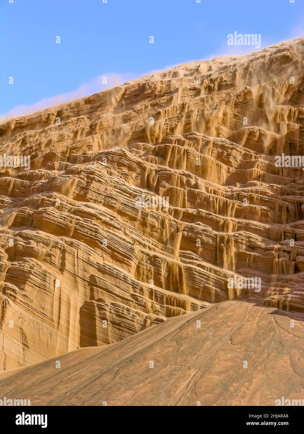 A 'waterfall' of sand cascading from a dune in the desert near Dubai in ...