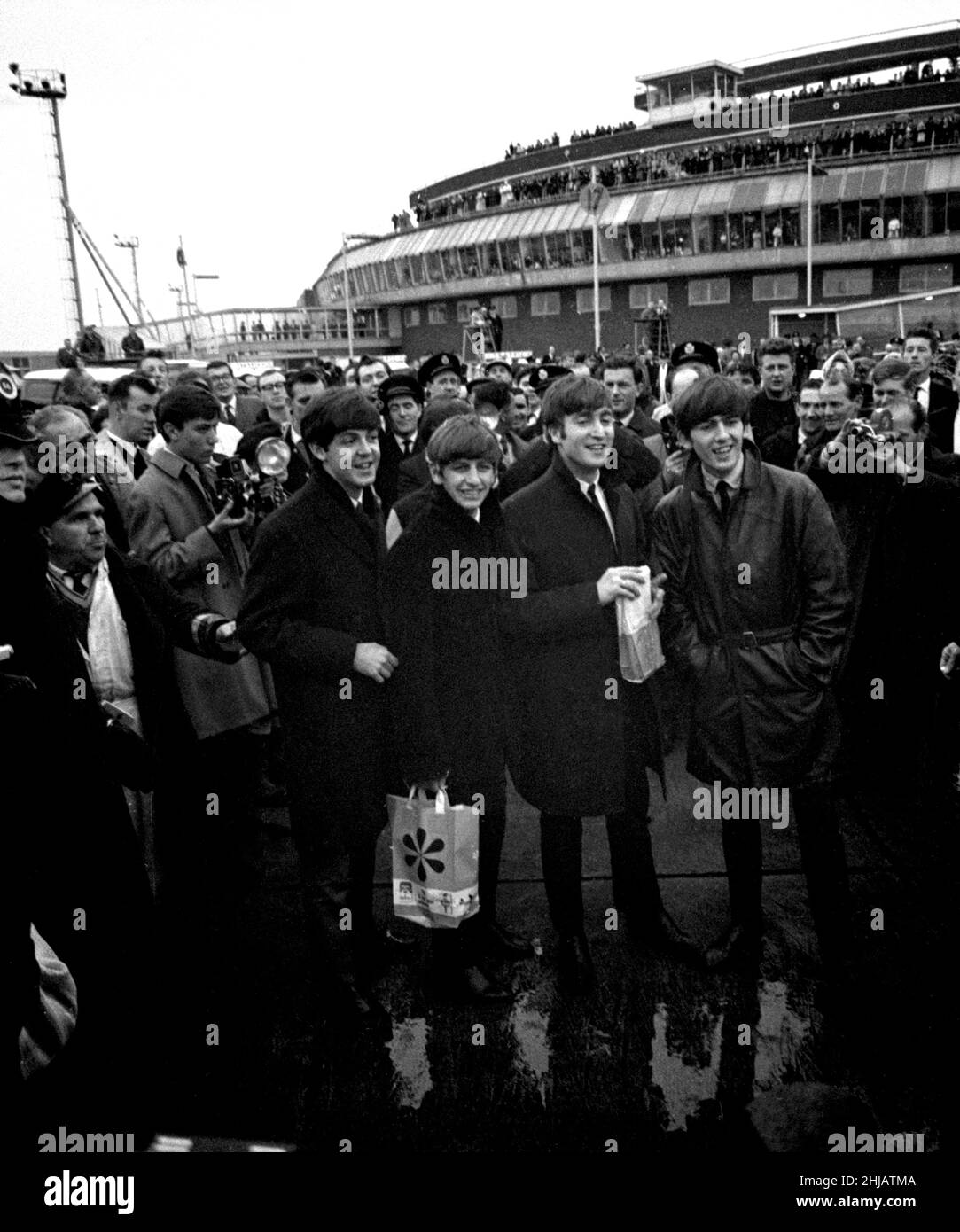 The Beatles arrive at London airport from Sweden. Surrounded by police ...