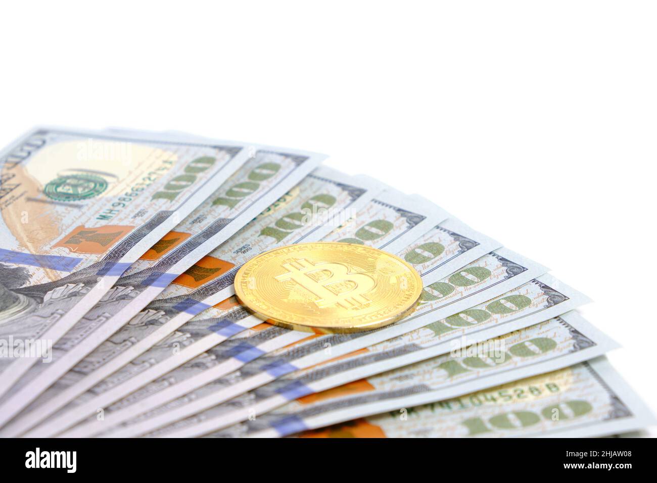An unfolded bundle hundred dollar bills and one bitcoin coin on white ...