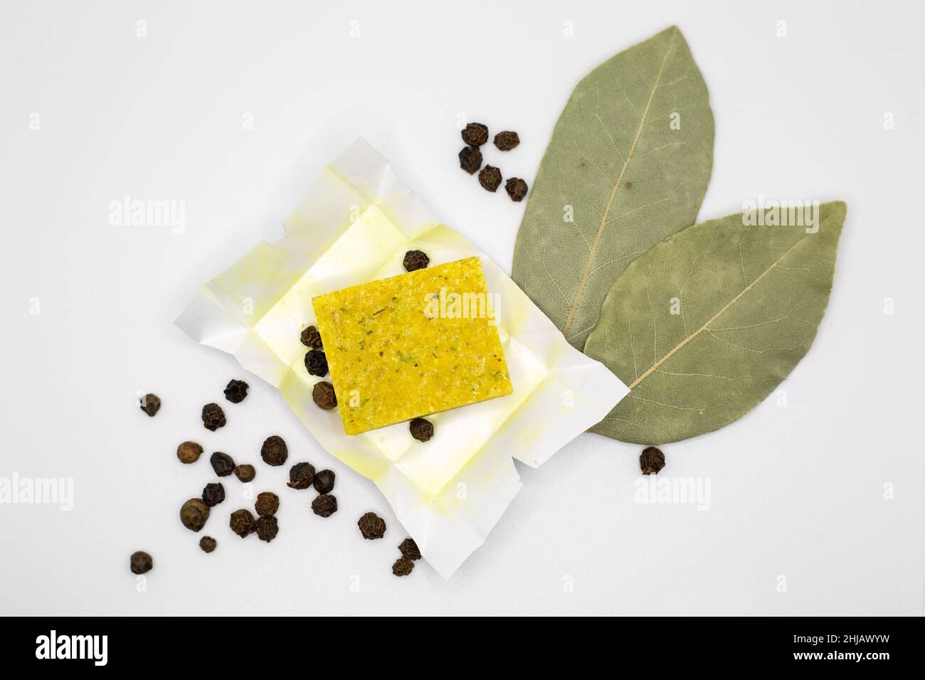 Dry chicken broth with bay leaf and black pepper white background ...