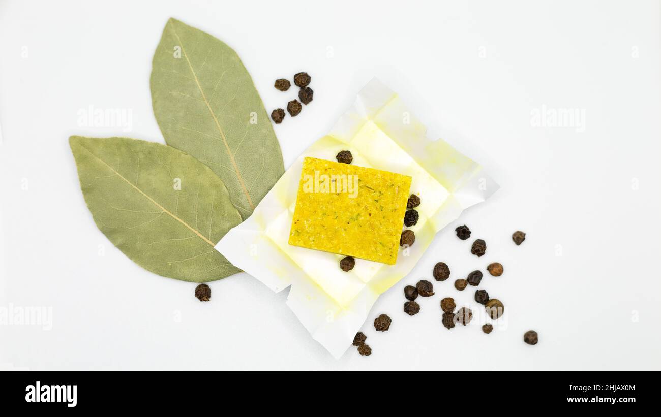 Dry chicken broth with bay leaf and black pepper on a white background ...
