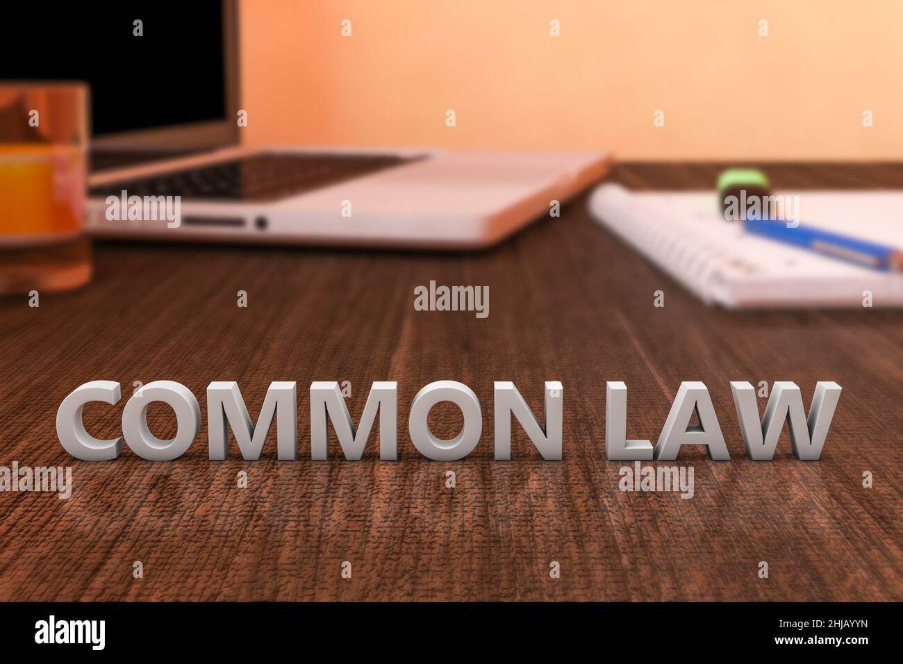 Common Law - letters on wooden desk with laptop computer and a notebook ...