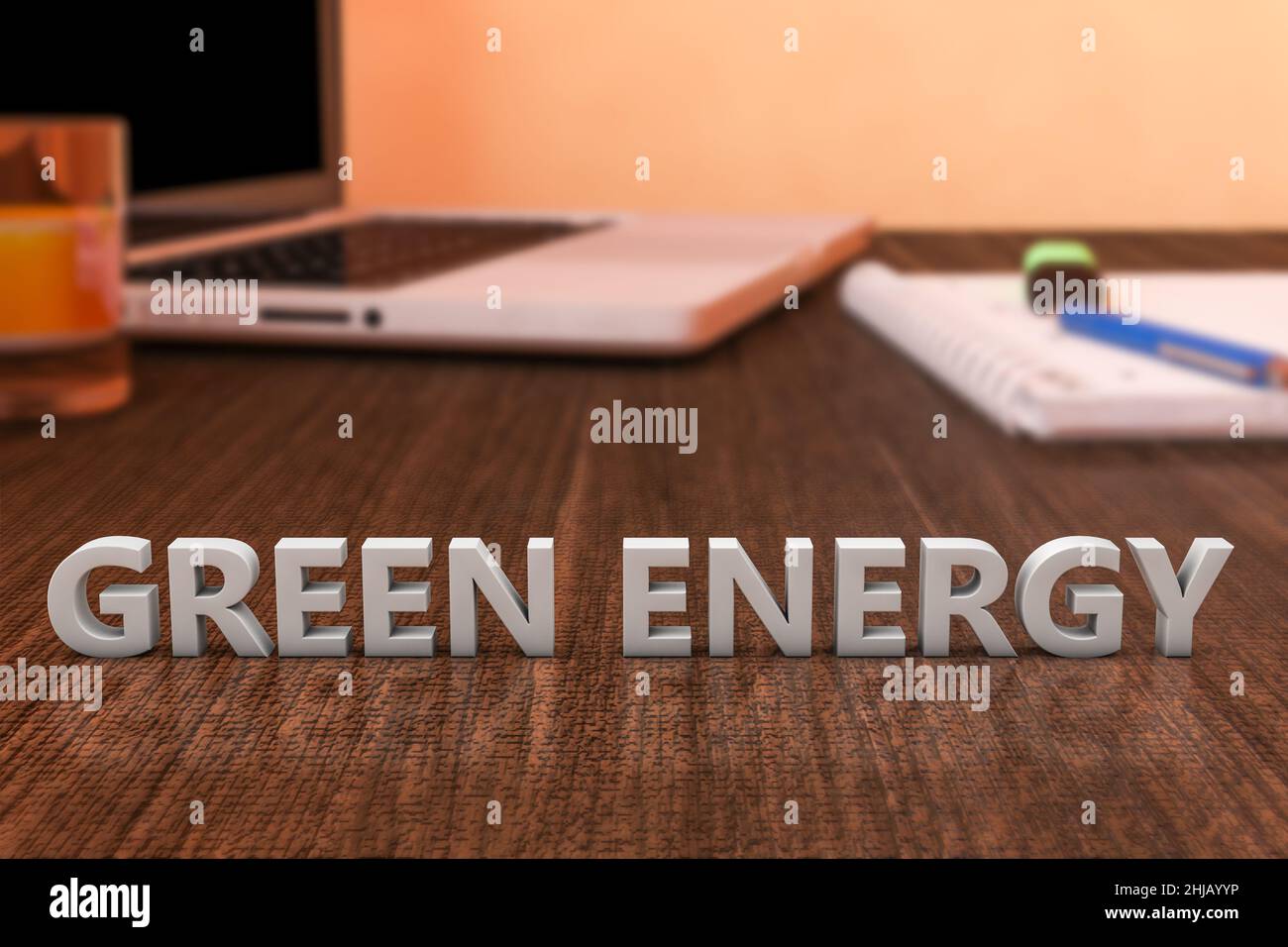 Green Energy - letters on wooden desk with laptop computer and a ...
