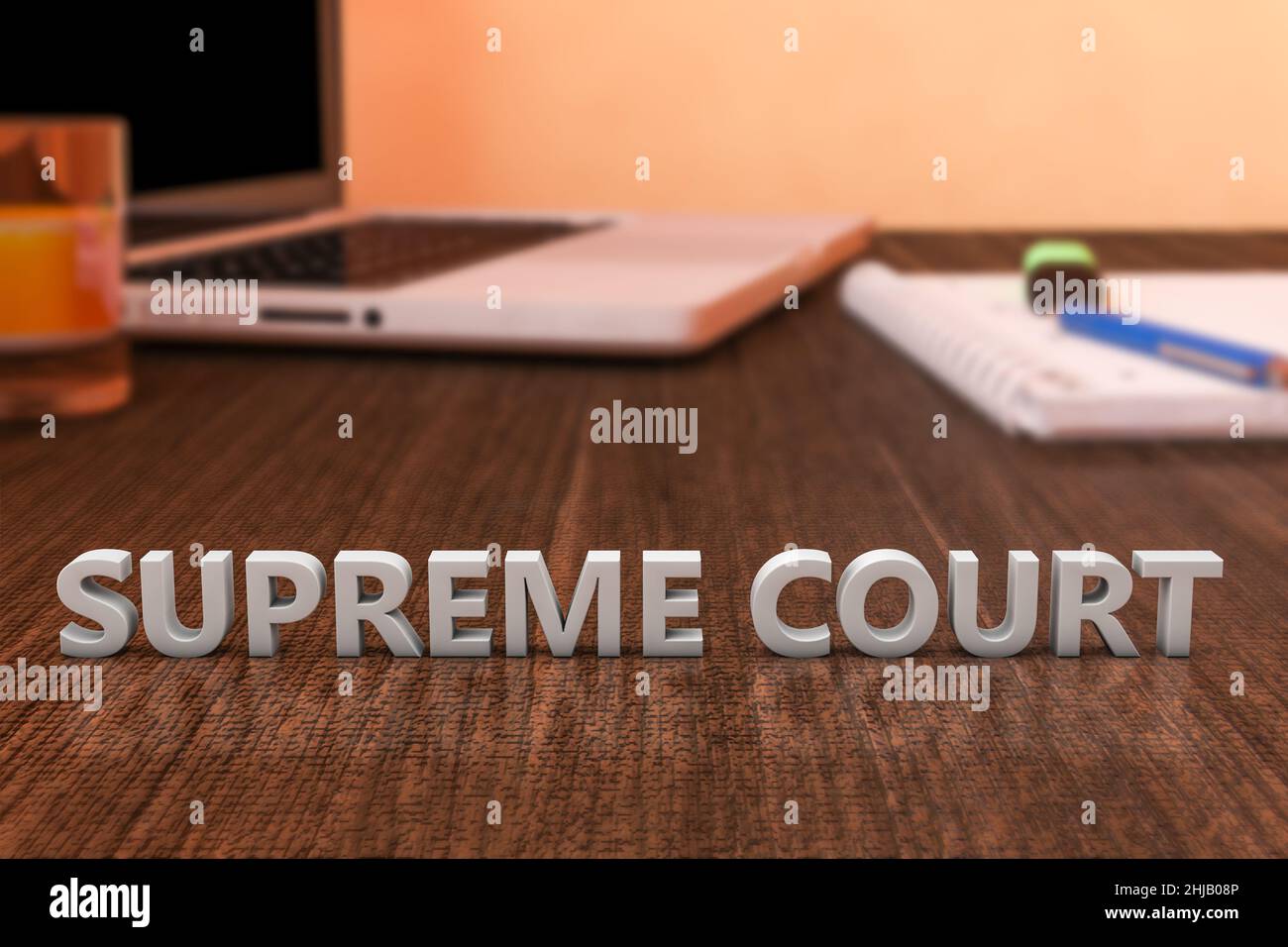 Supreme Court - letters on wooden desk with laptop computer and a ...