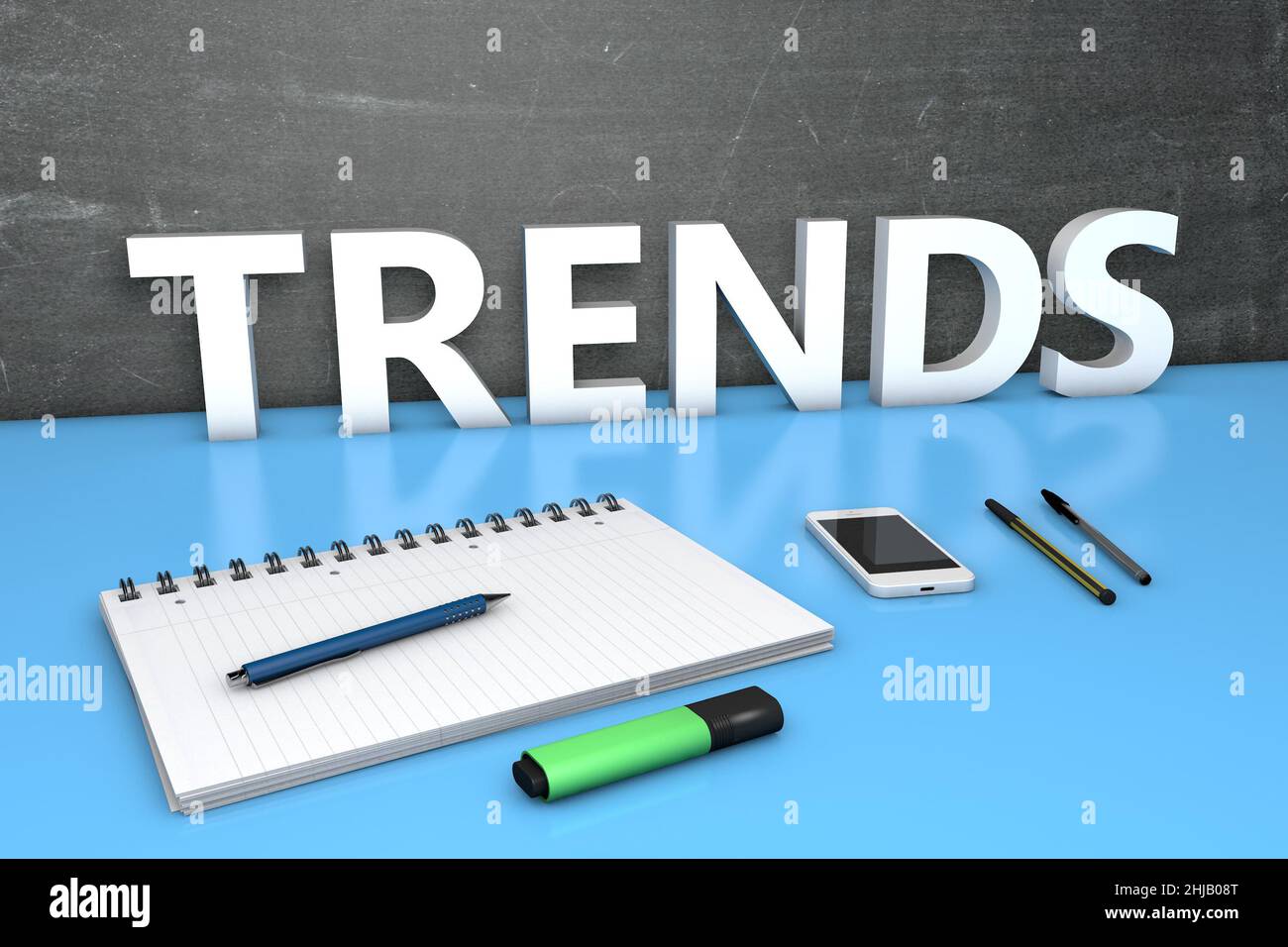 Trends - text concept with chalkboard, notebook, pens and mobile phone ...
