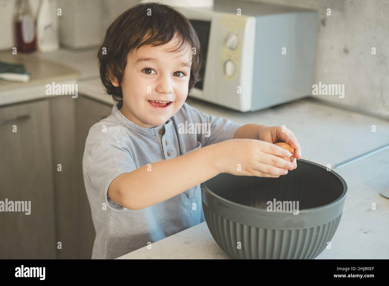 A little boy is cooking in the kitchen Stock Photo - Alamy