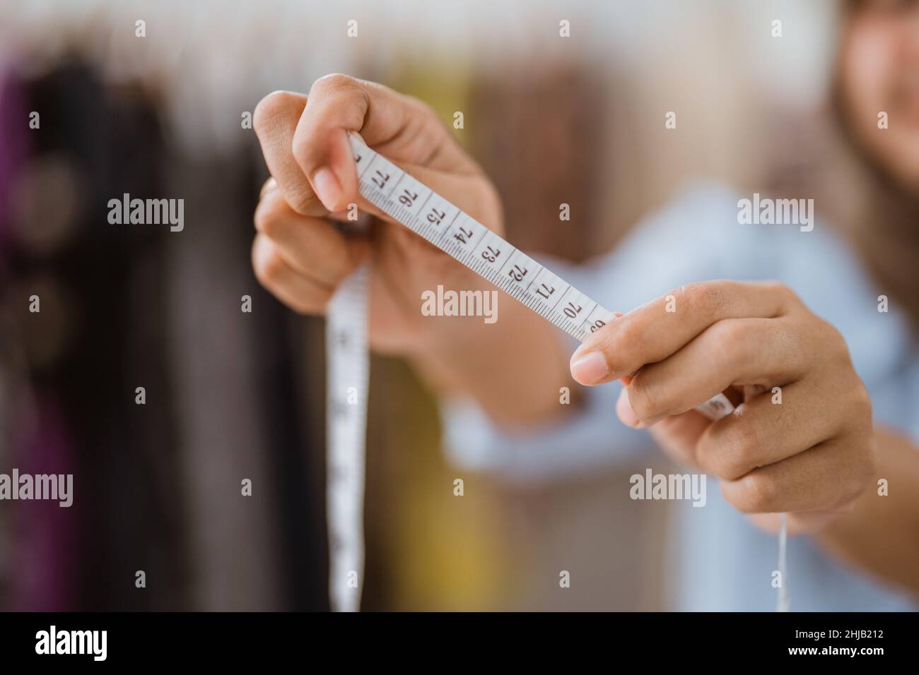 hand holding tape measure for making a dress Stock Photo - Alamy