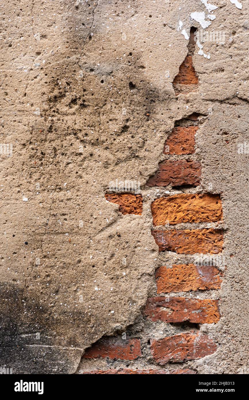 Brown grunge and rough cement wall with cracking part show inside brick ...