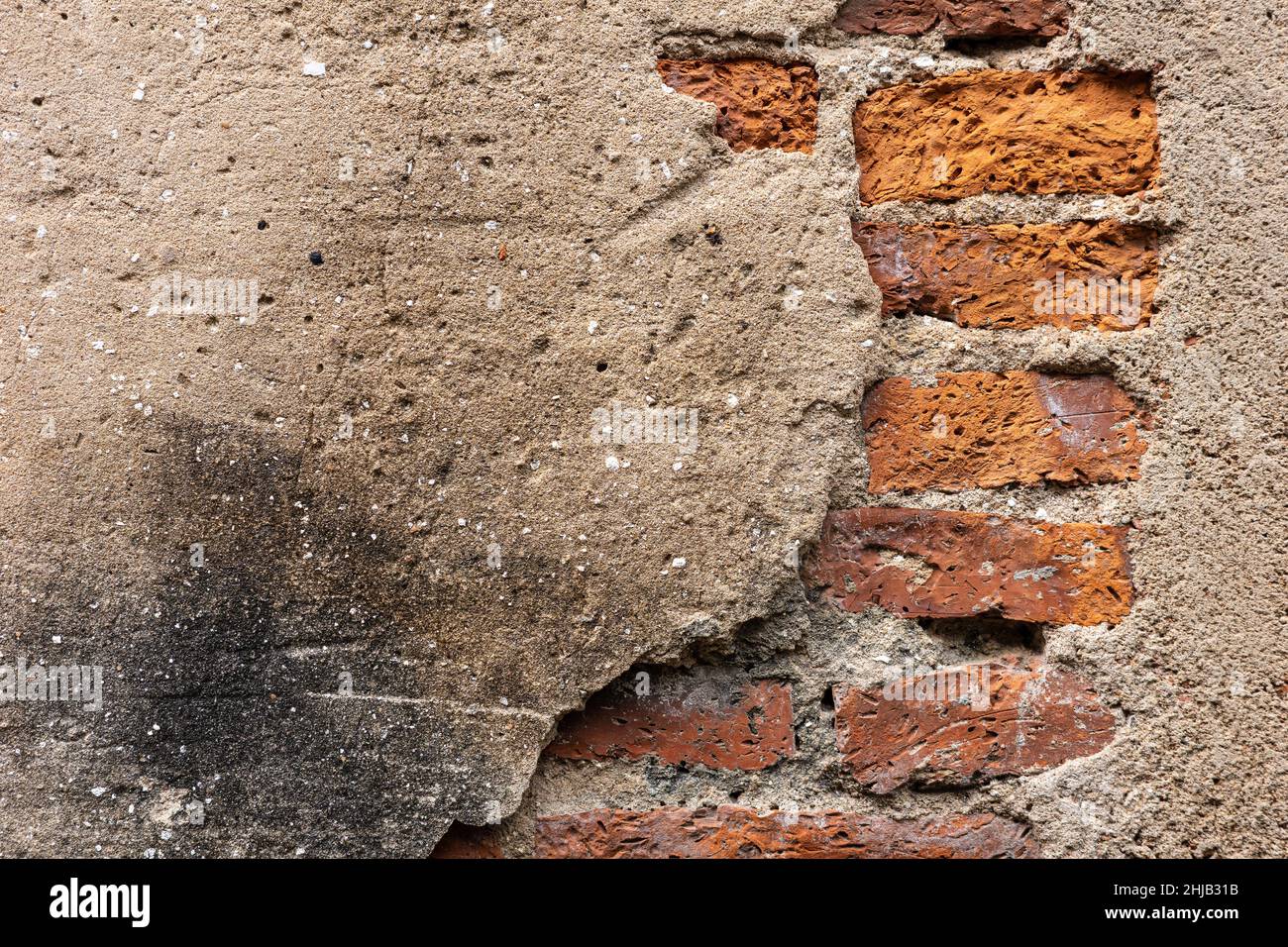 Brown grunge and rough cement wall with cracking part show inside brick ...