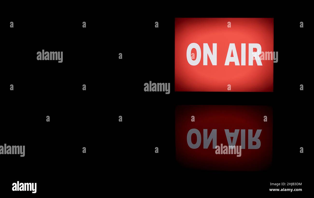 Closeup of an "on air" neon light banner with reflection copy space ...