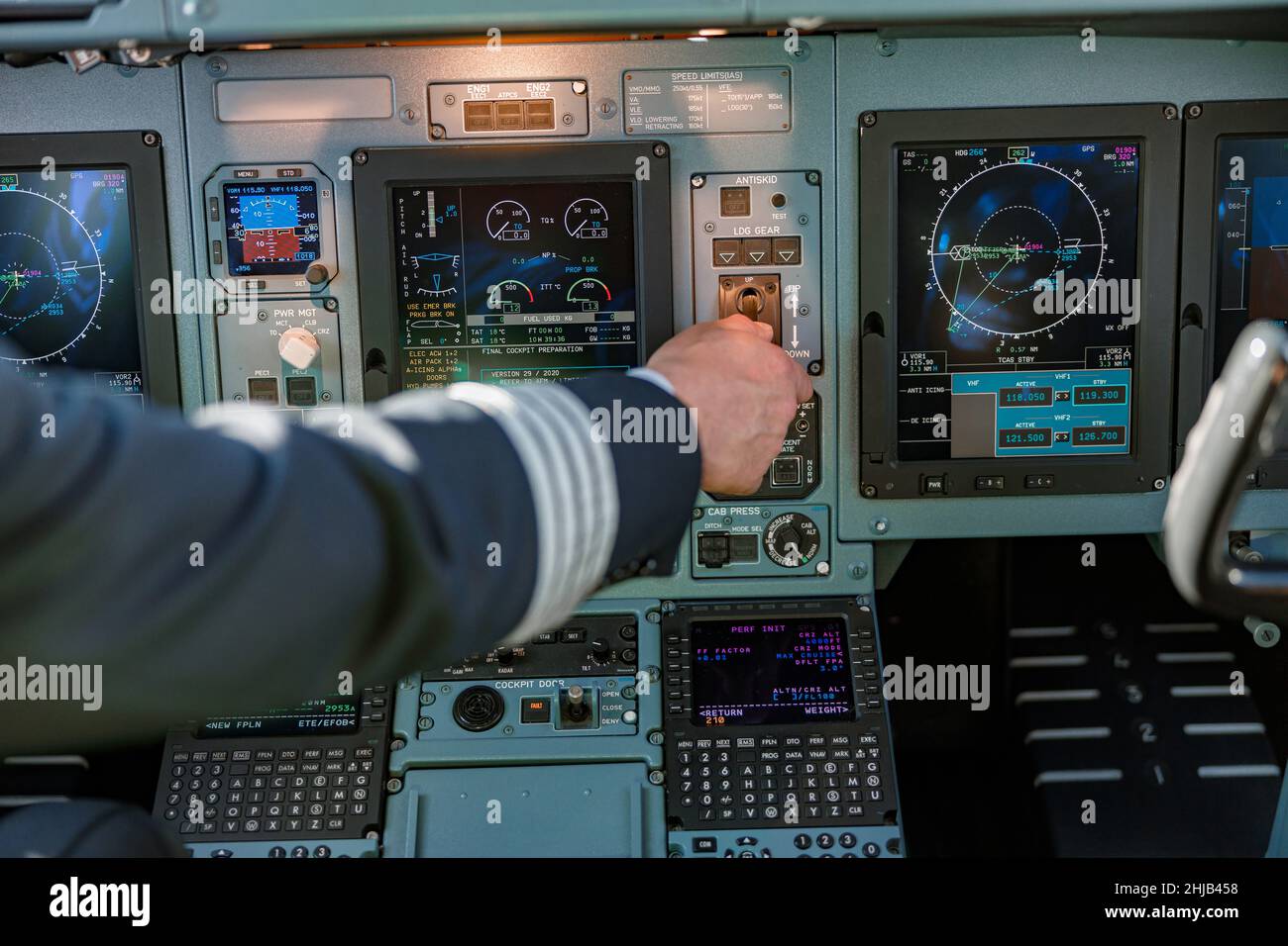Airline pilot using control panel in aircraft cockpit Stock Photo - Alamy