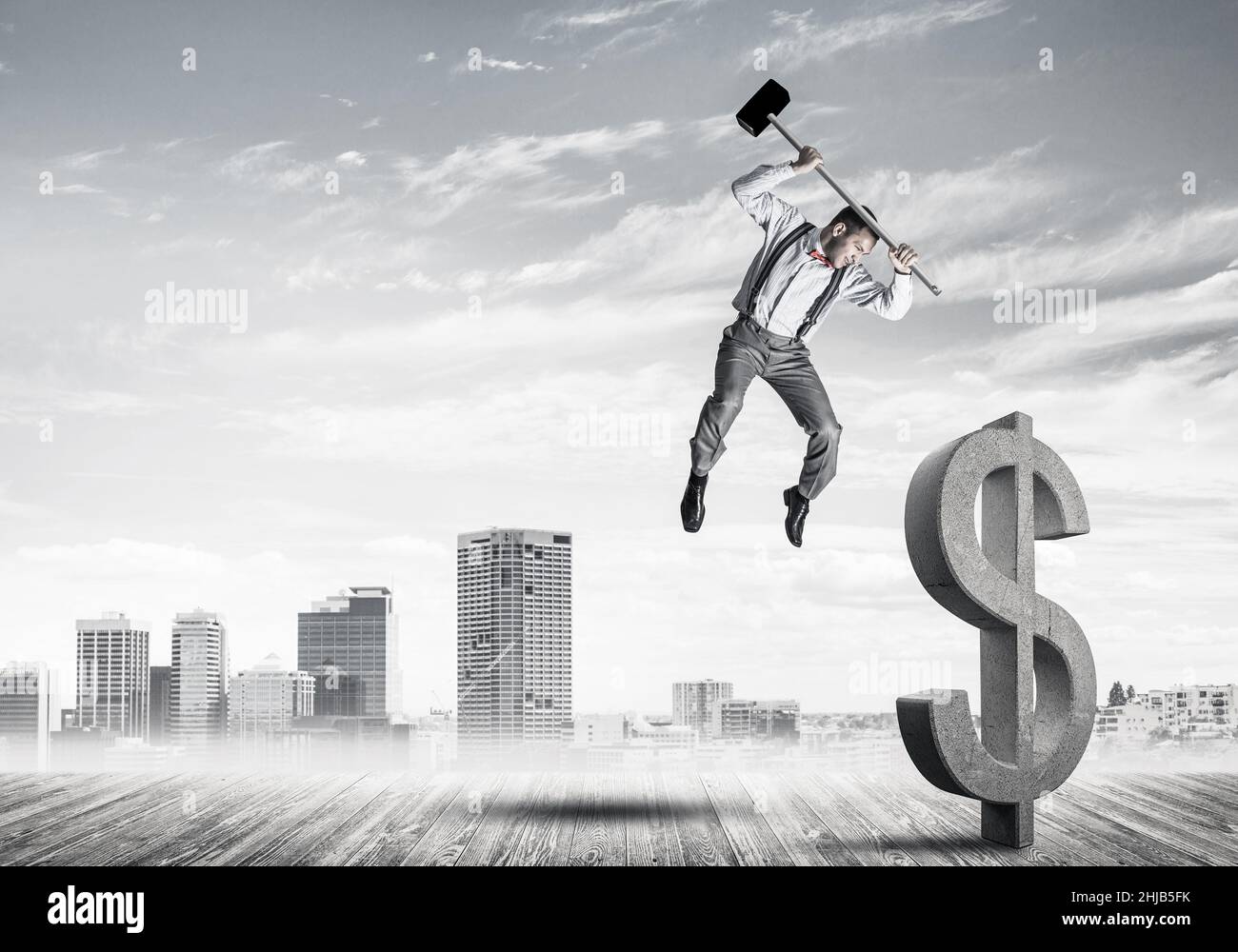 Determined banker man against modern cityscape breaking dollar concrete ...