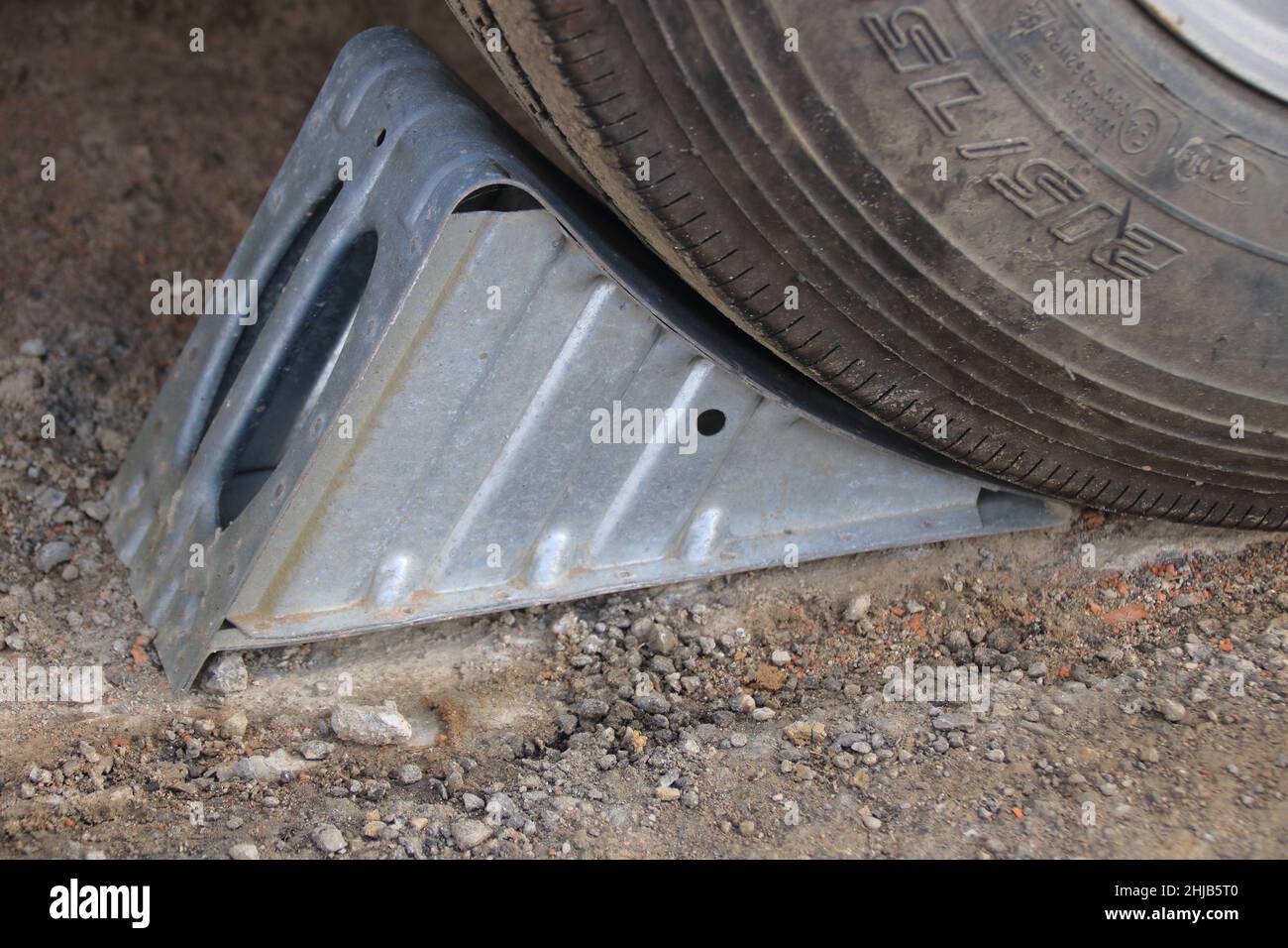 The trailer is secured against rolling away with a wedge Stock Photo ...