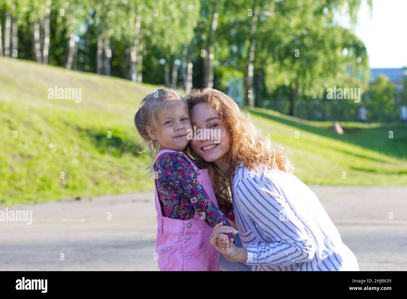 Young girl holding hands with the smiling and beautiful child Stock ...