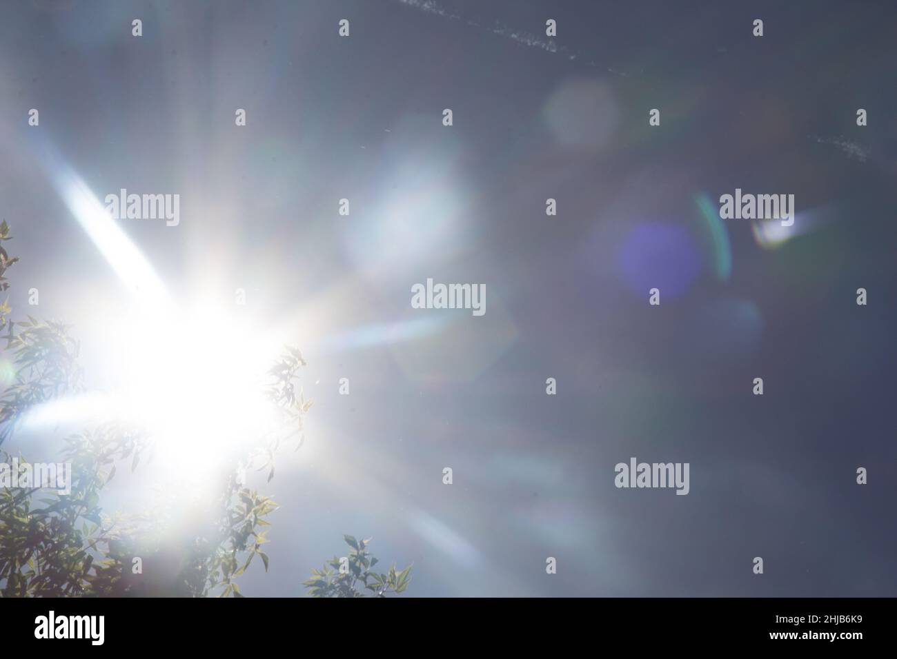 View of blue sky with bright lights from sun Stock Photo - Alamy