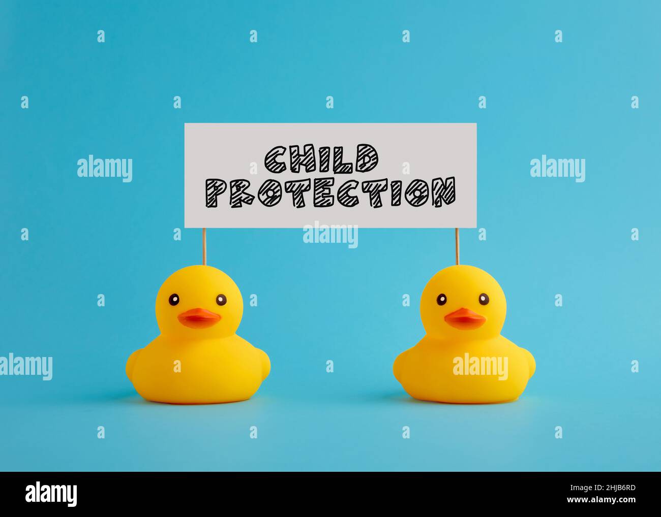 Rubber ducks carry a signboard with the message child protection Stock ...
