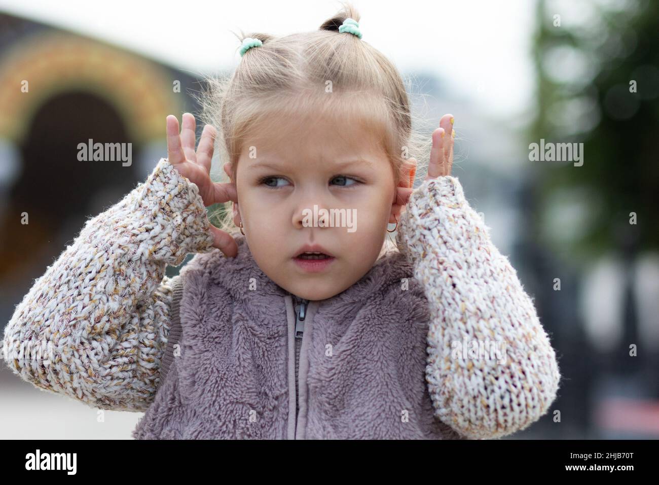 Child does not want to hear anything closing her ears by hands Stock ...