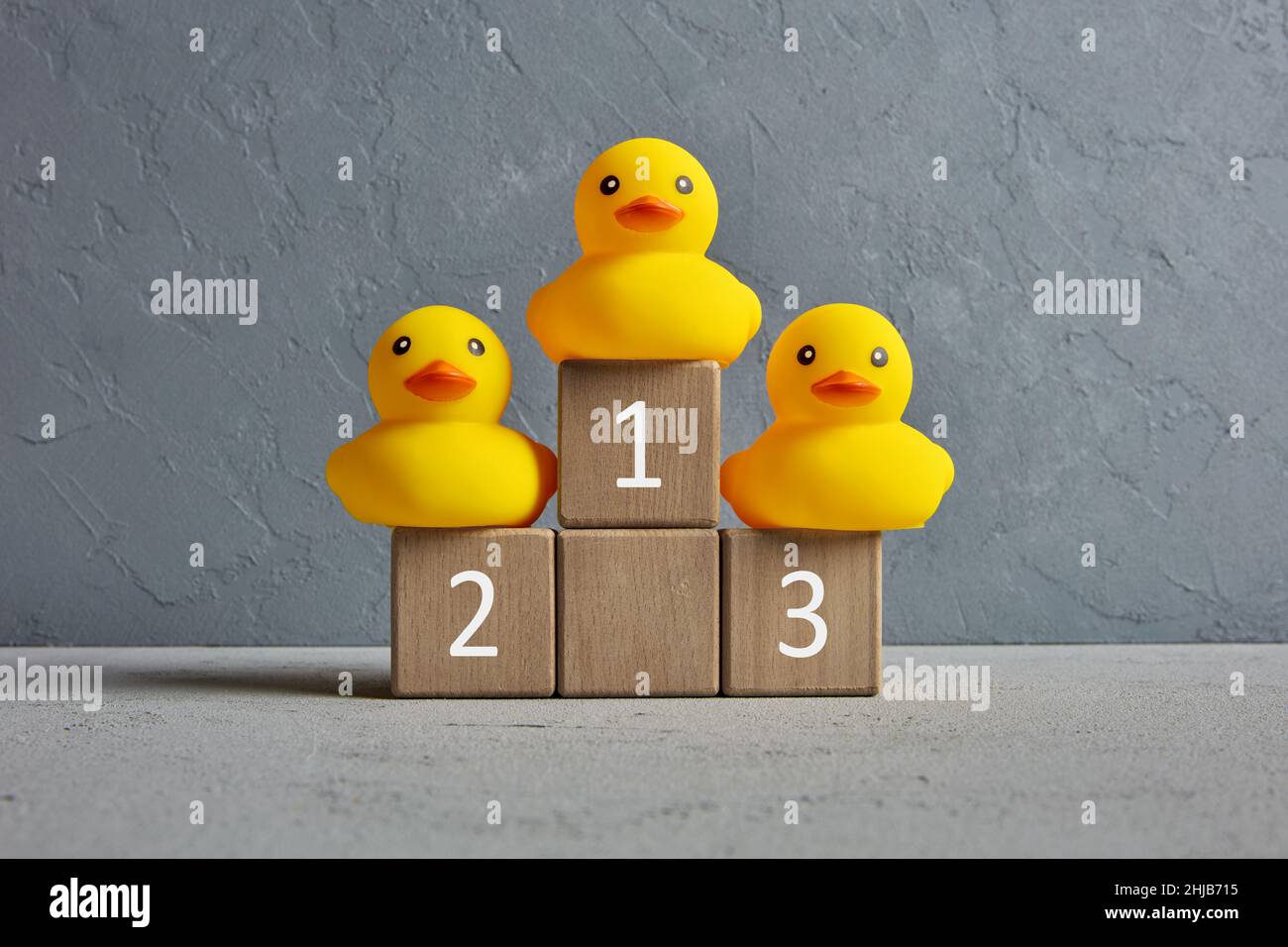 Rubber ducks ranked on a winner podium with numbers. Business ...