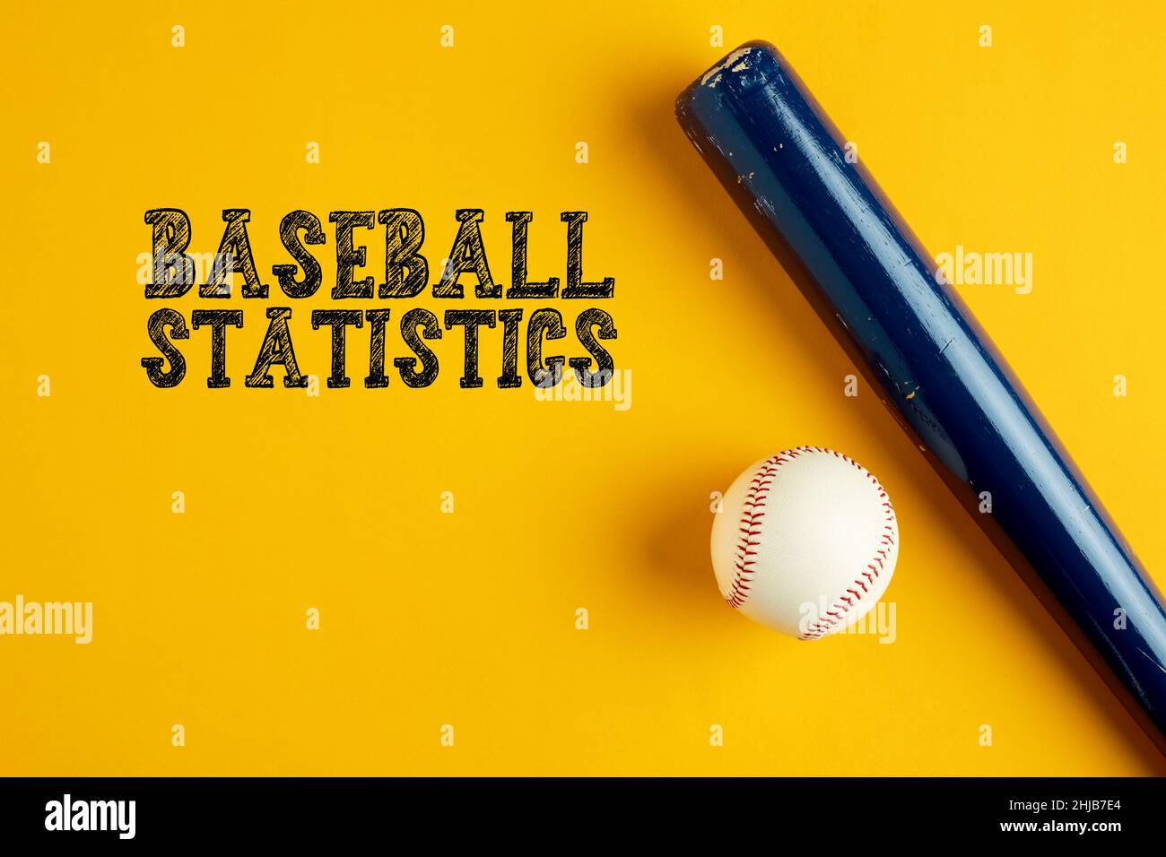 Wooden baseball bat and a ball on yellow background with the word ...