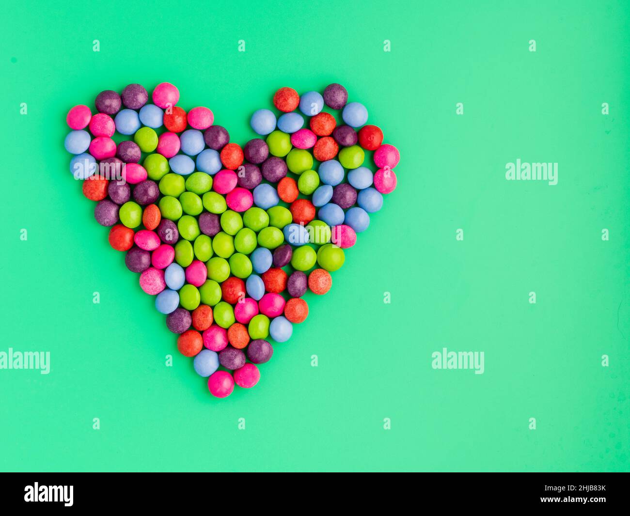 Delicious candy valentine day heart. Lots of colorful candies are ...