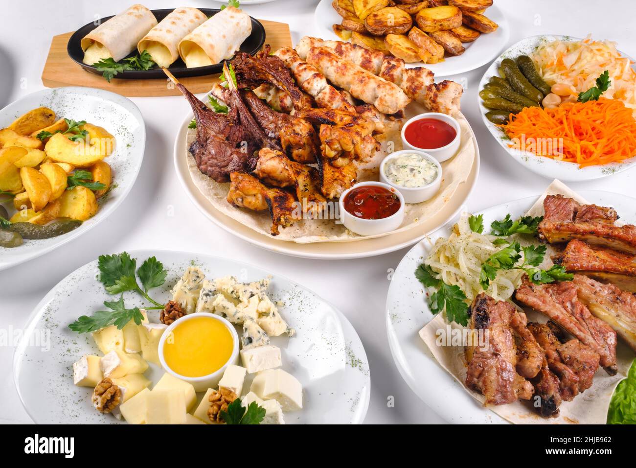 A covered table with many different dinner dishes. Lots of food on a ...