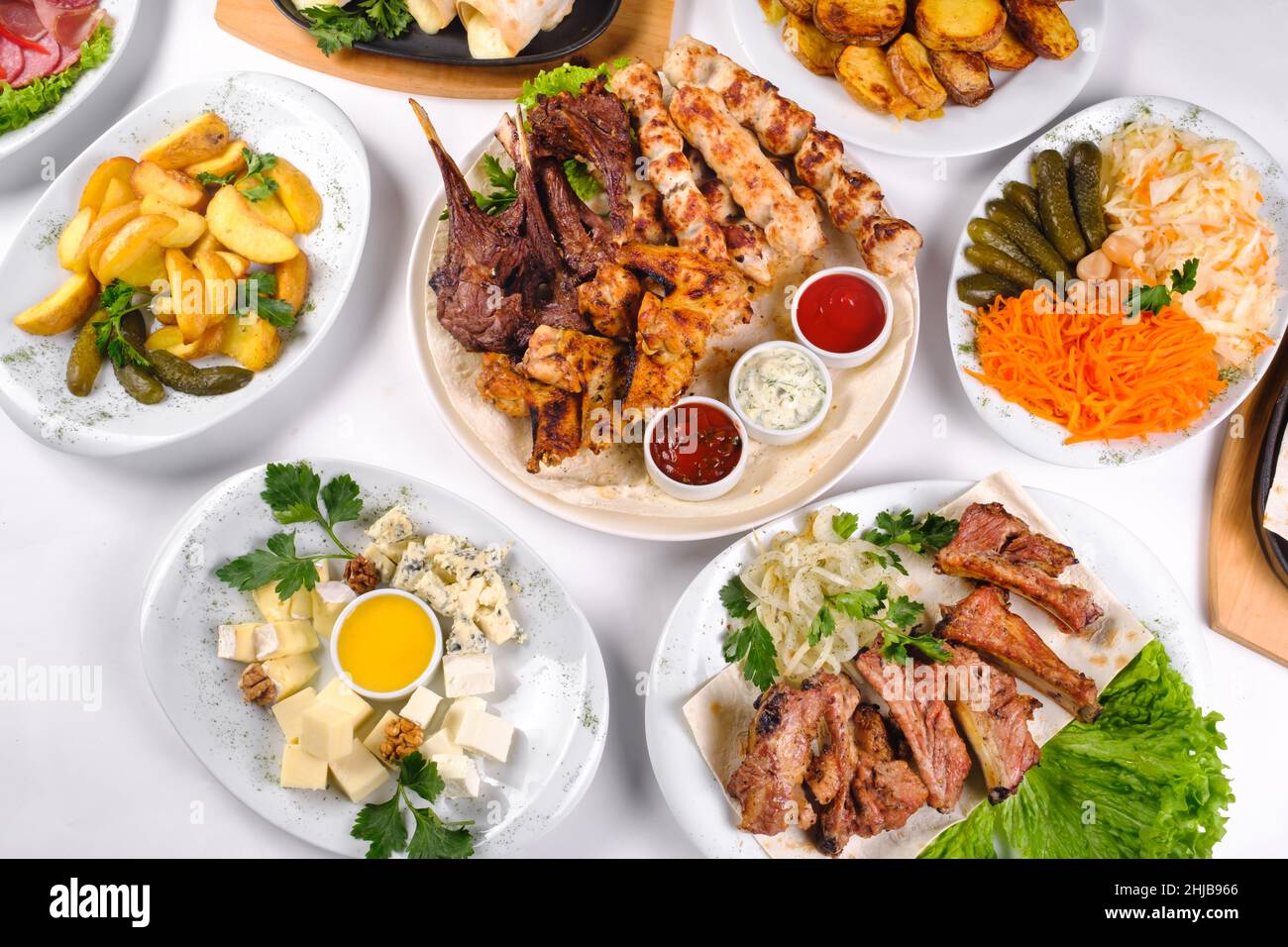 A covered table with many different dinner dishes. Lots of food on a ...