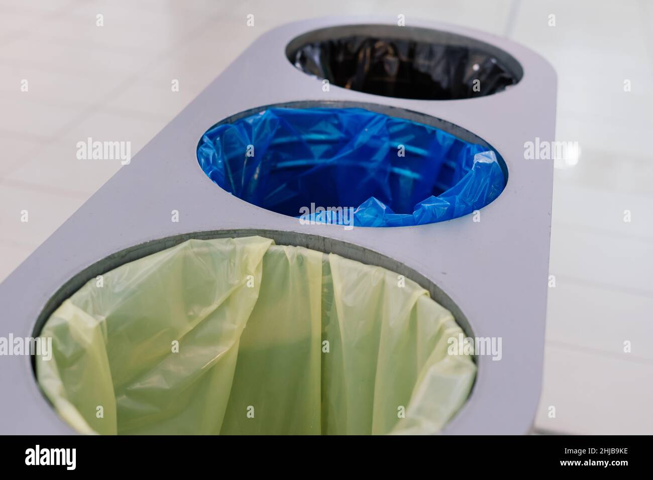 Close up of garbage and recycle bins inside in business center on a ...
