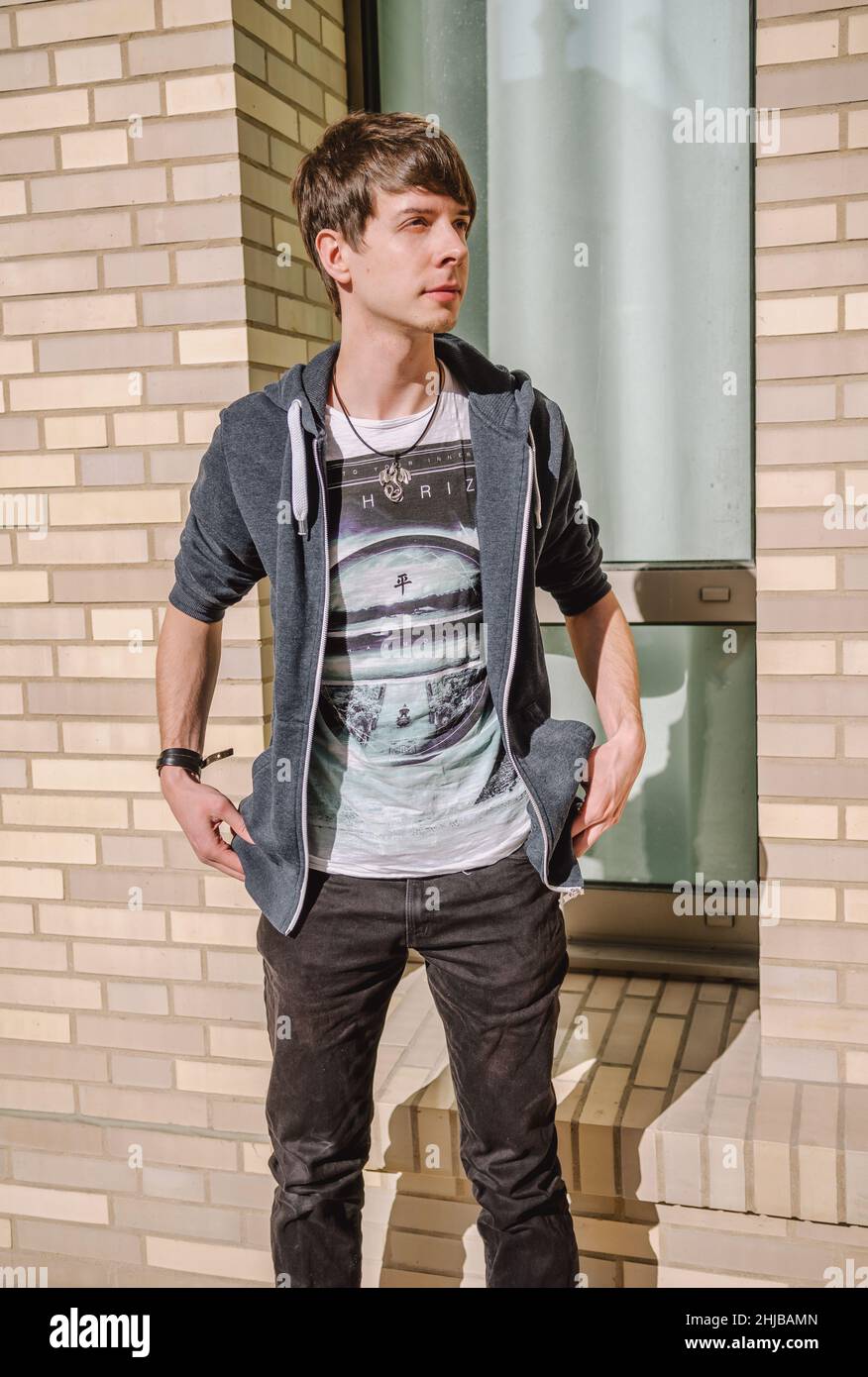 Young adult rock musician, view from the side, singer wearing a blue ...