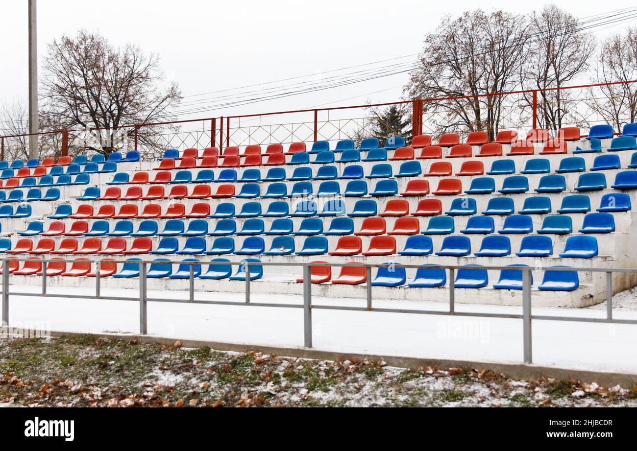 Places where fans sit, plastic chairs in a football stadium, in winter ...