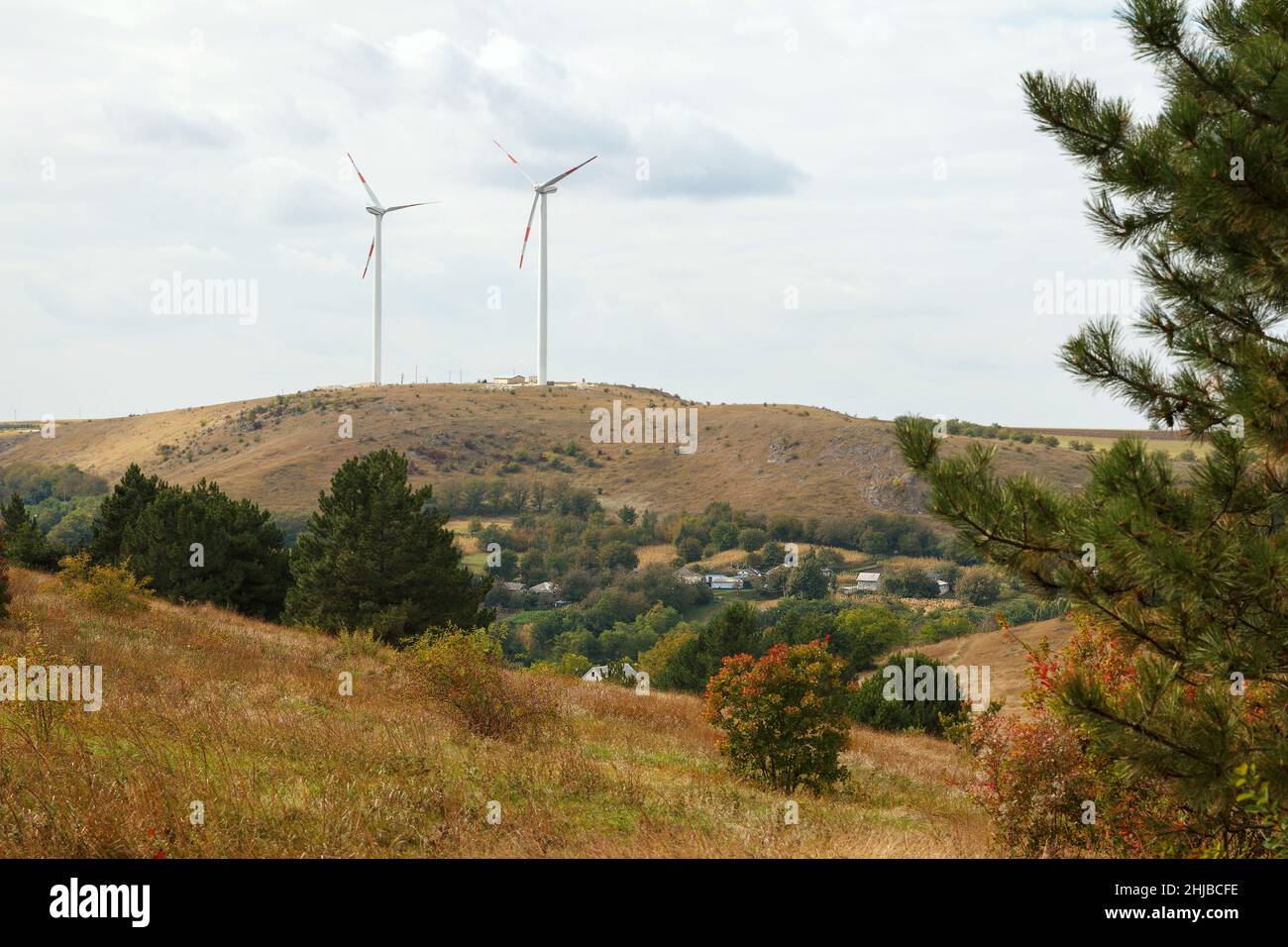 Landscape of hilly autumn forest with vertical wind farms and with ...