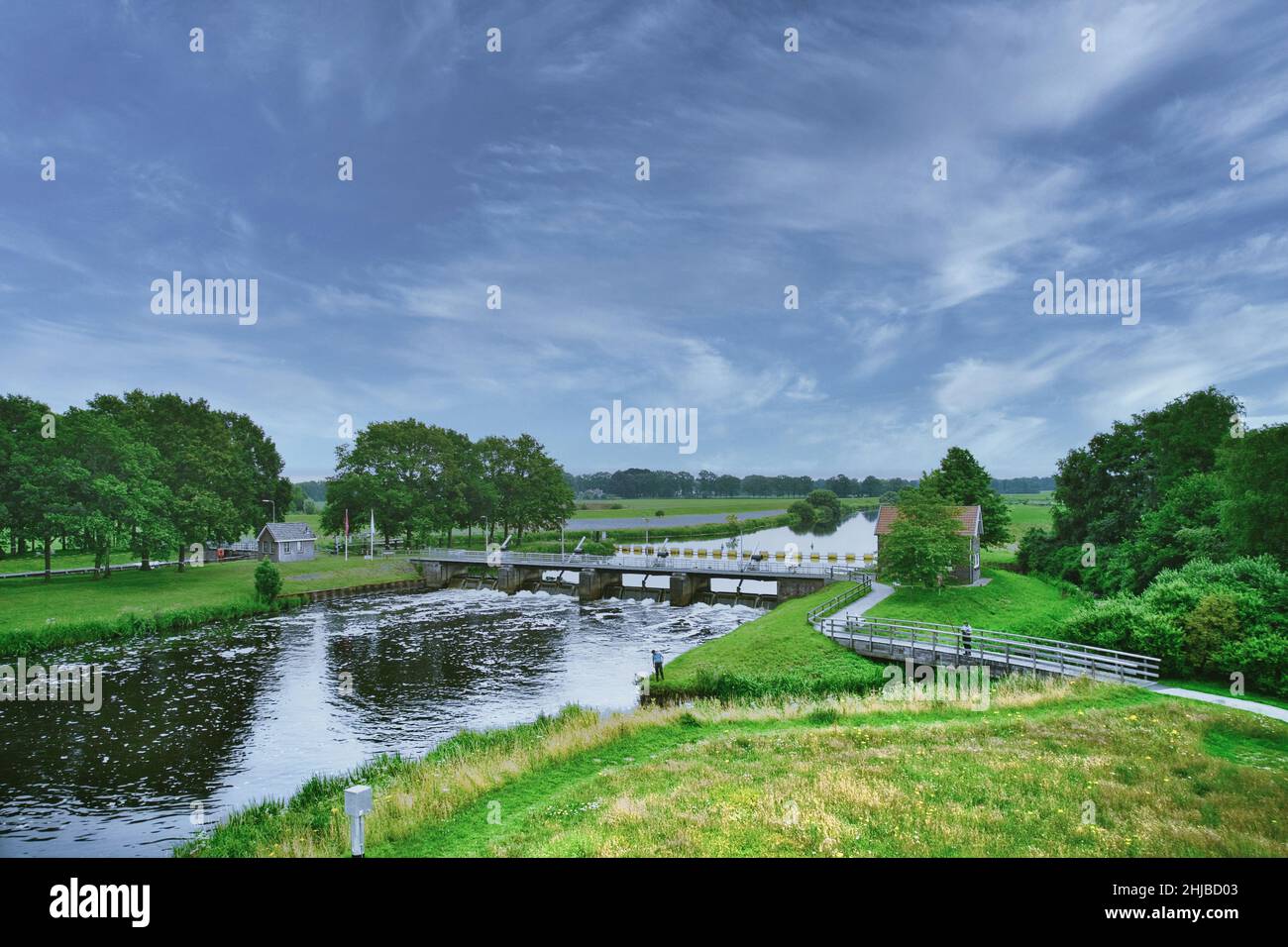 Drone view of the river Vecht, green grass, trees, beautiful blue sky ...