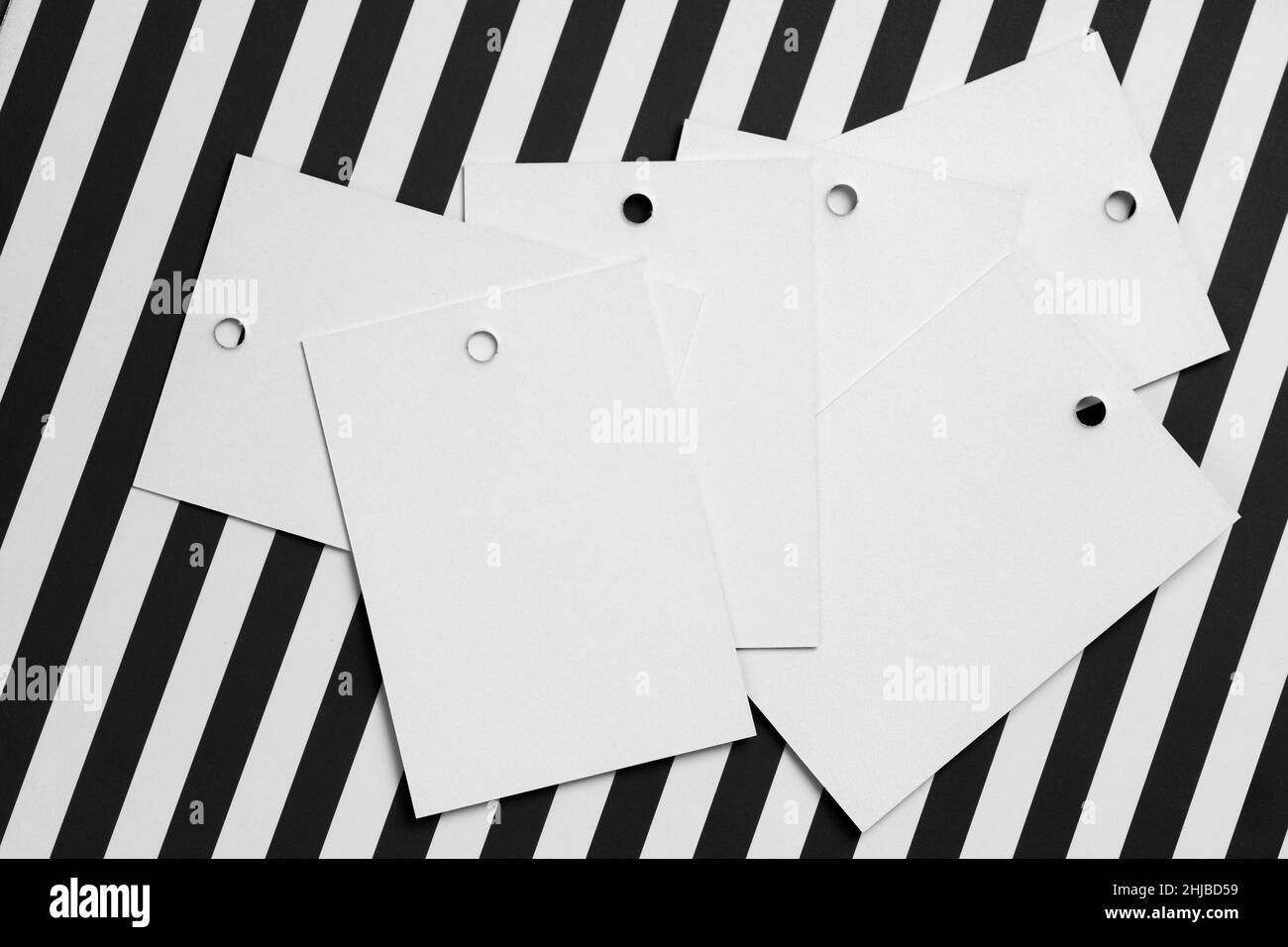 Stack of white cardboard label tags for clothes with little holes in ...