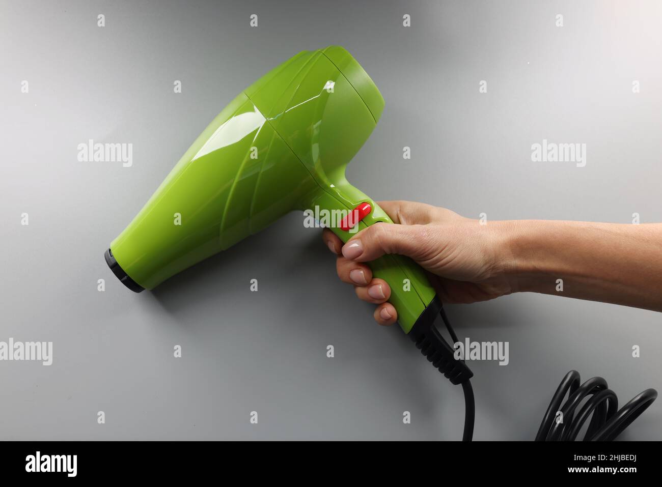 Brand new hairdryer model, bright green device for drying hair in hand ...