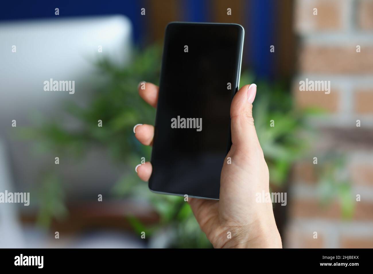 Woman hold in hand smartphone with black screen, turn off mobile phone ...