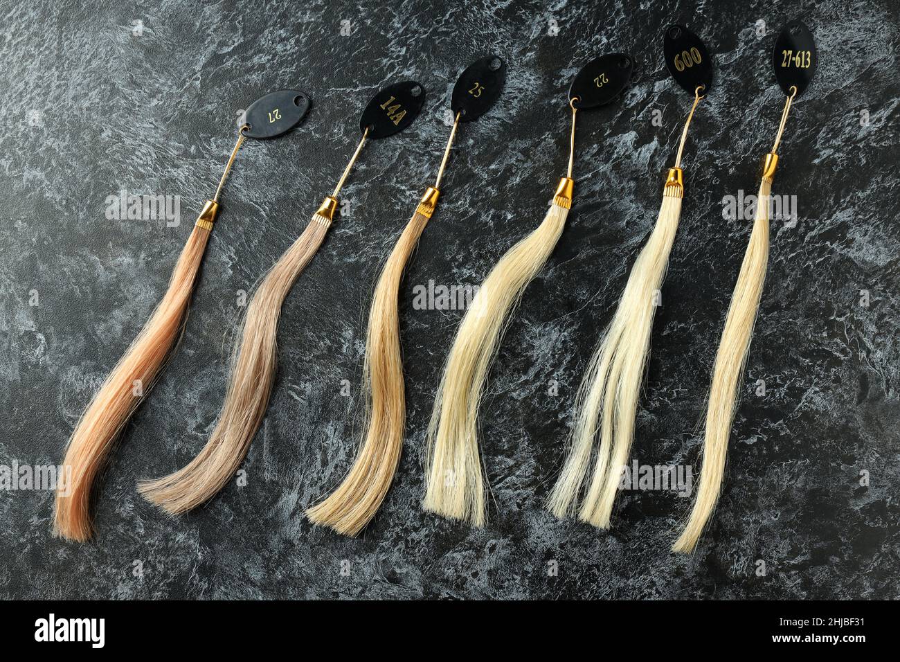 Female hair samples on black smokey background Stock Photo - Alamy