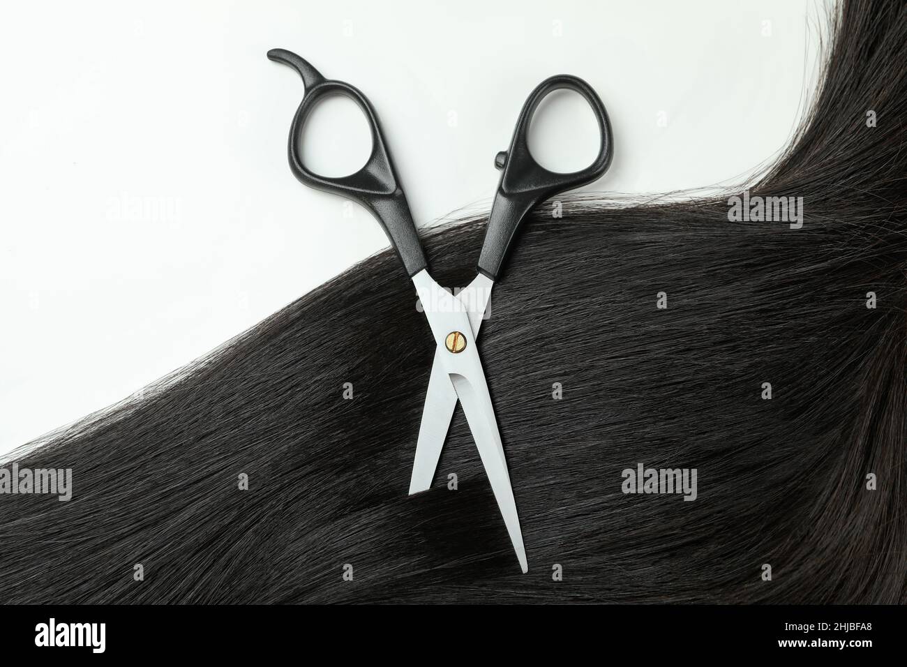 Female hair with scissors on white background Stock Photo - Alamy