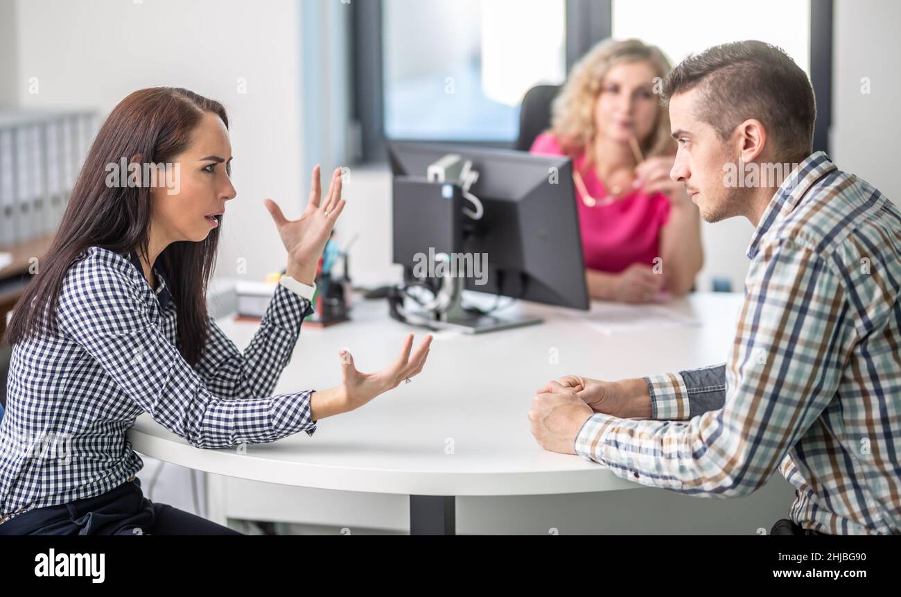 Woman gesticulates to a man angry over disagreement with demale ...