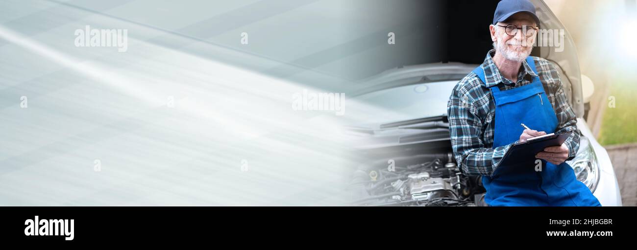 Car mechanic checking a car engine and writing on clipboard; panoramic ...
