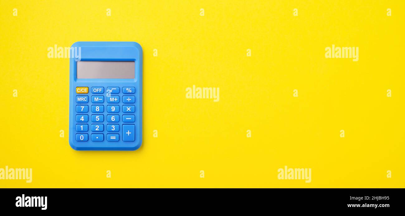 Blue calculator on yellow background with copy space, top view Stock ...