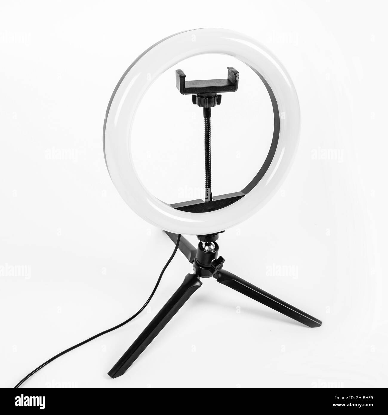 LED ring lamp on a small tripod. White background Stock Photo - Alamy