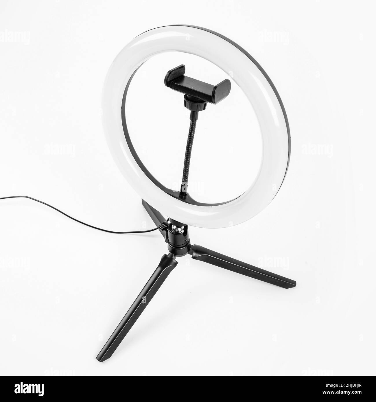 LED ring lamp on a small tripod. White background Stock Photo - Alamy